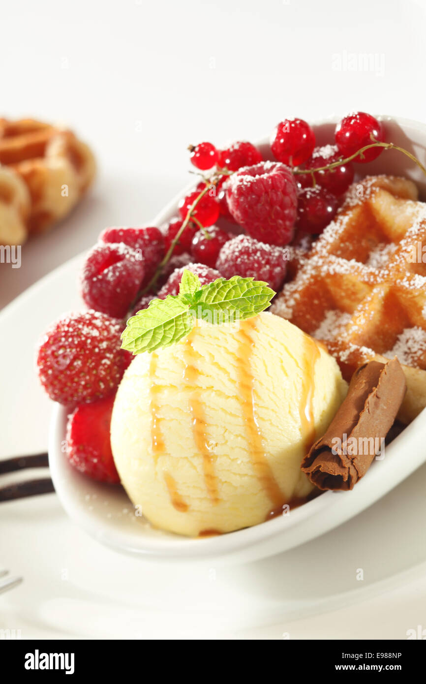 Tilted perspective of a serving of a crisp golden waffle with an ...