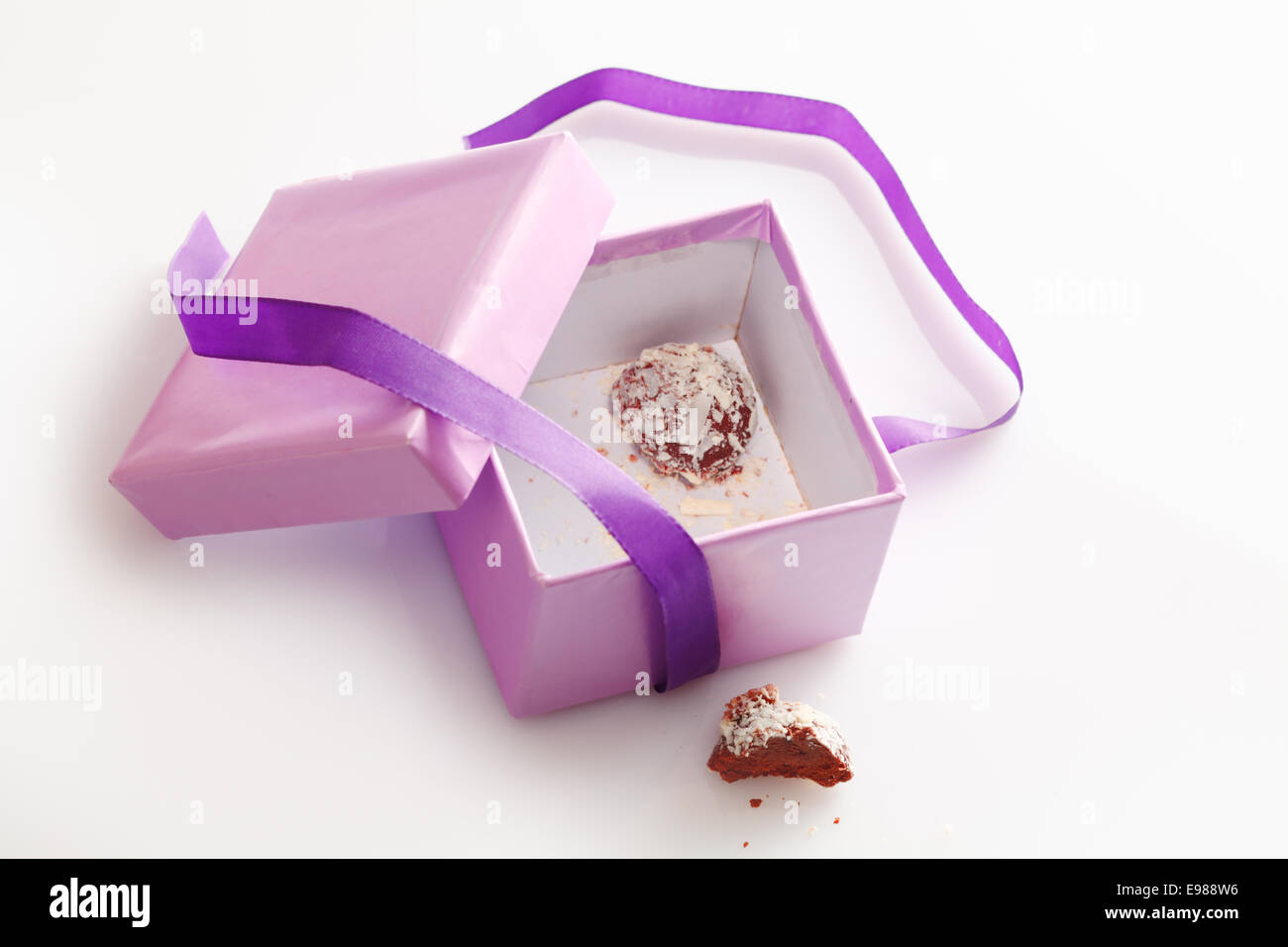 Pretty lilac-coloured gift box with a decorative matching ribbon open ...