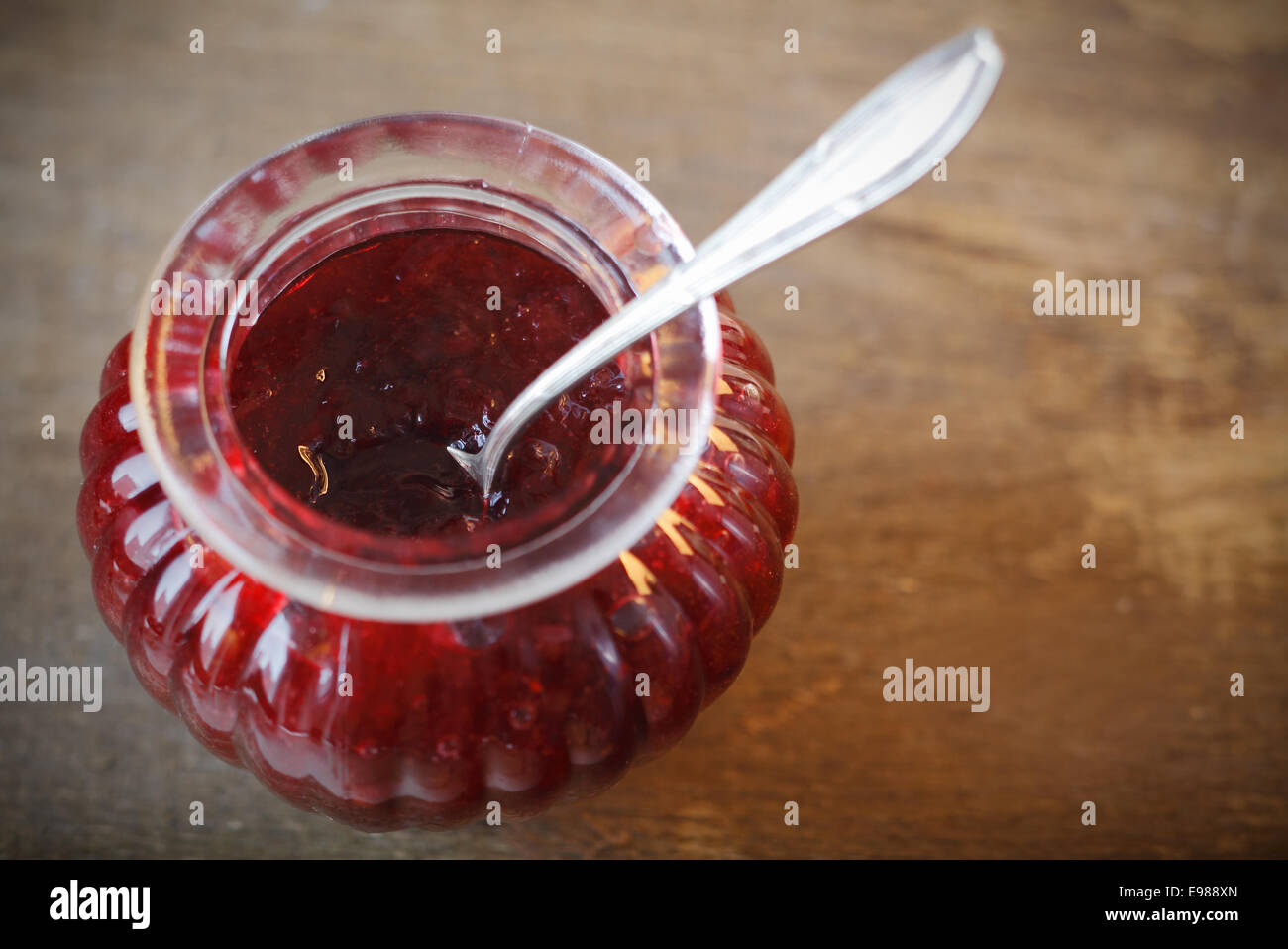 Overhead view of a decorative fluted glass jar filled with fresh fruity ...