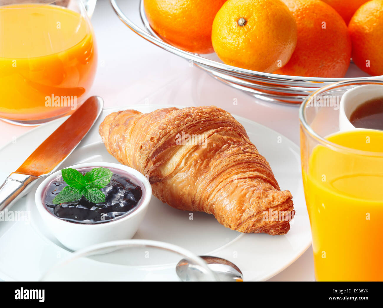 Table setting with a tasty Continental breakfast including fresh ...