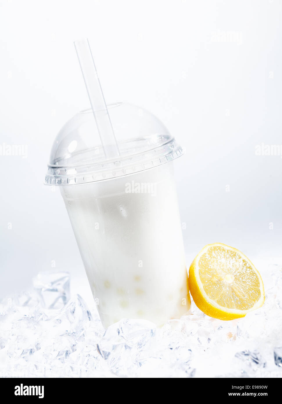 Tangy lemon boba tea with tapioca pearls in a covered glass chilled on ...