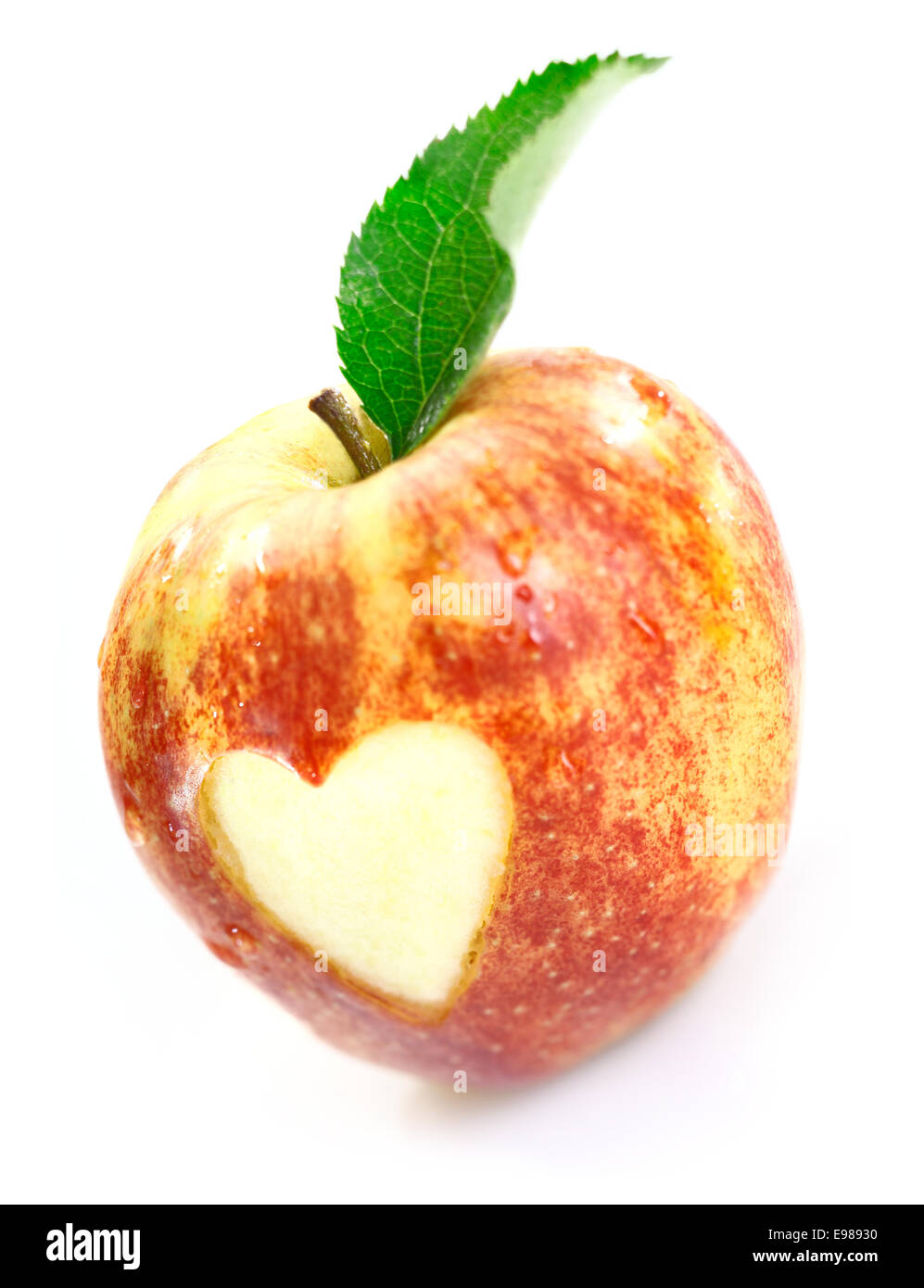 Luscious red apple with a heart cutout in the skin signifying love of ...