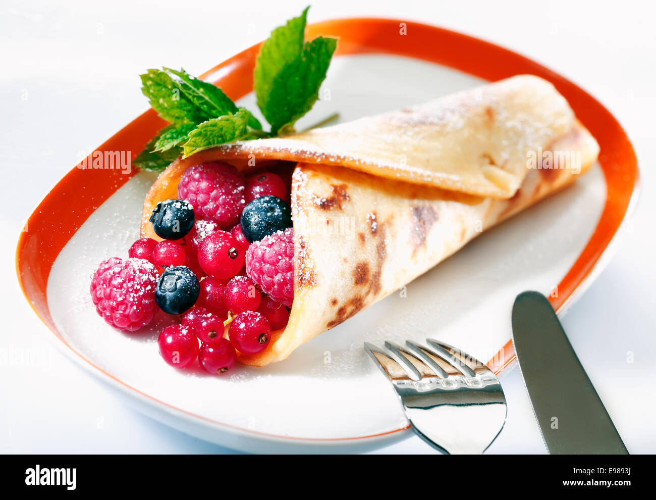 Golden panfried pancake filled with raspberries , blueberries and ...