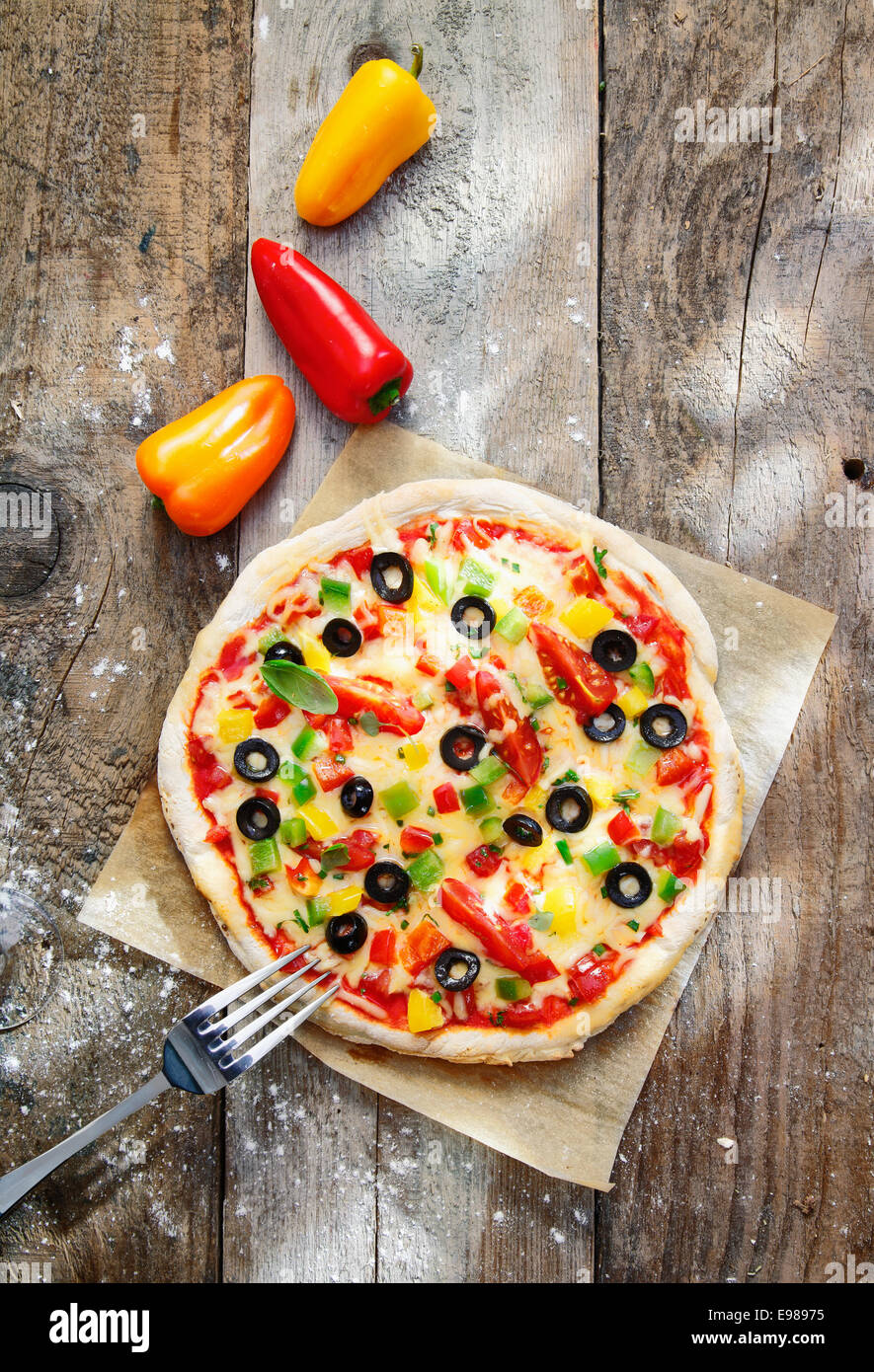 Overhead view of a delicious colourful homebaked pizza with a thick ...