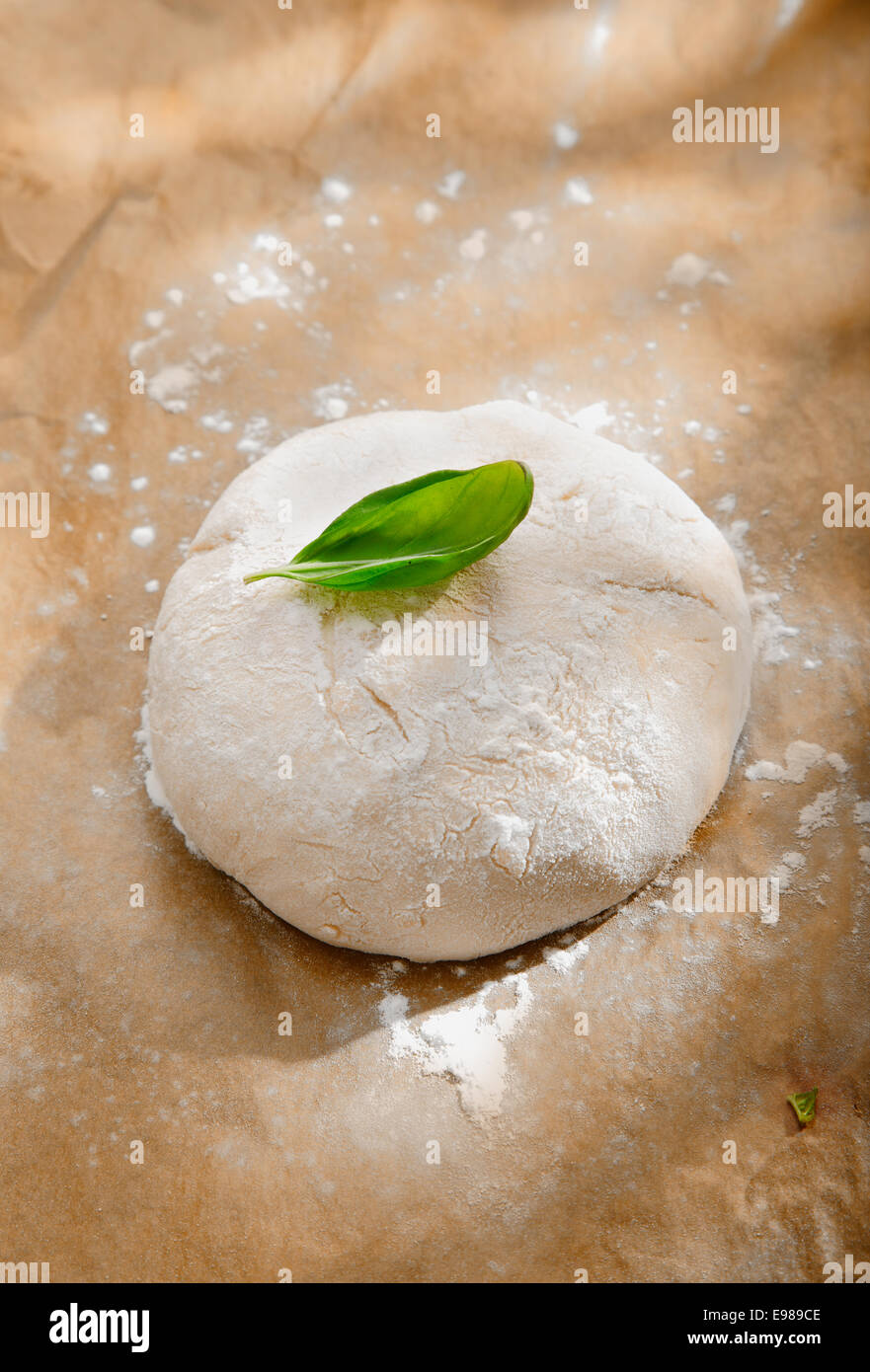 Fresh pizza dough for a pizza base left to rise before being rolled out ...