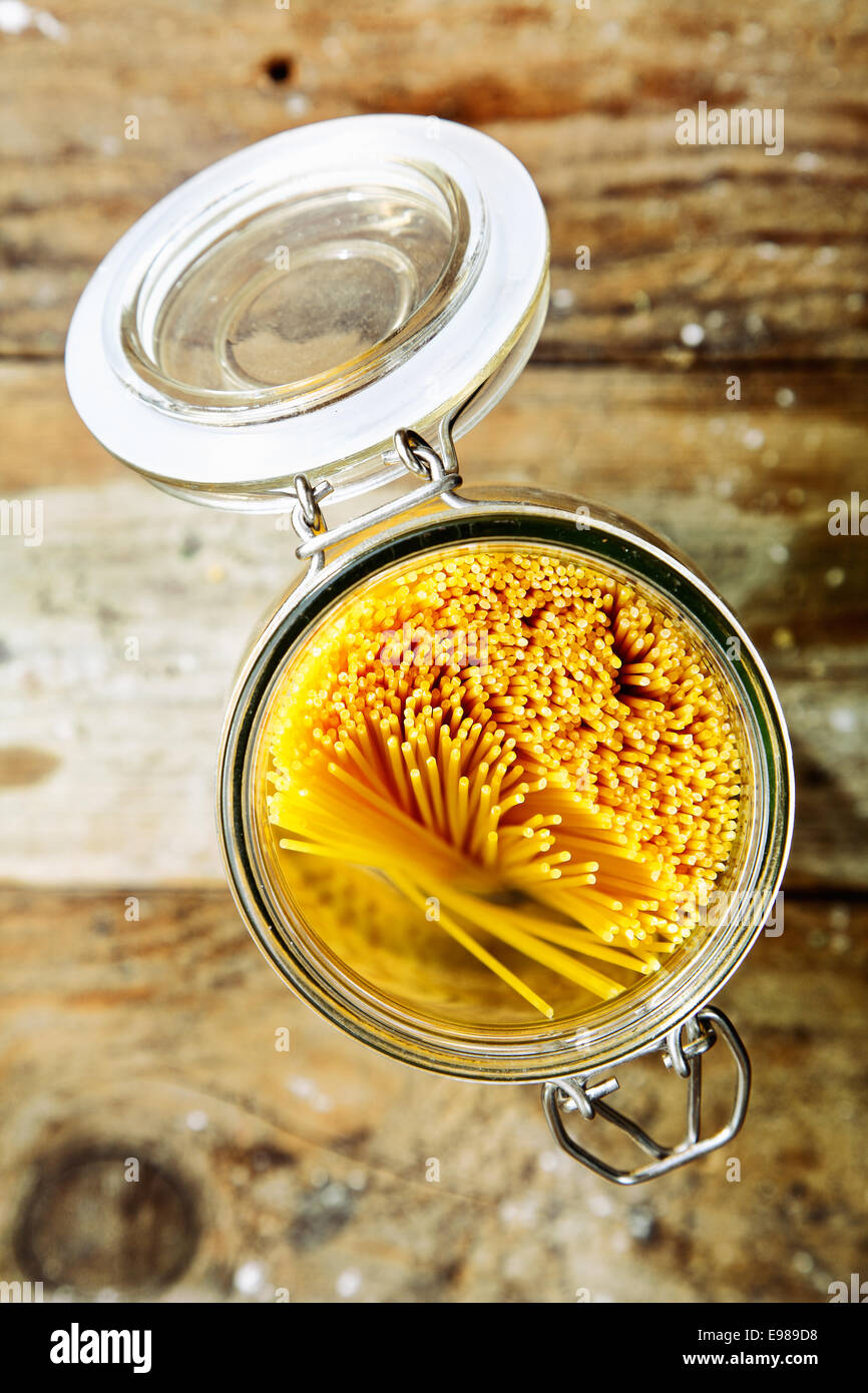 Overhead view of a kitchen container full of Italian spaghetti pasta ...