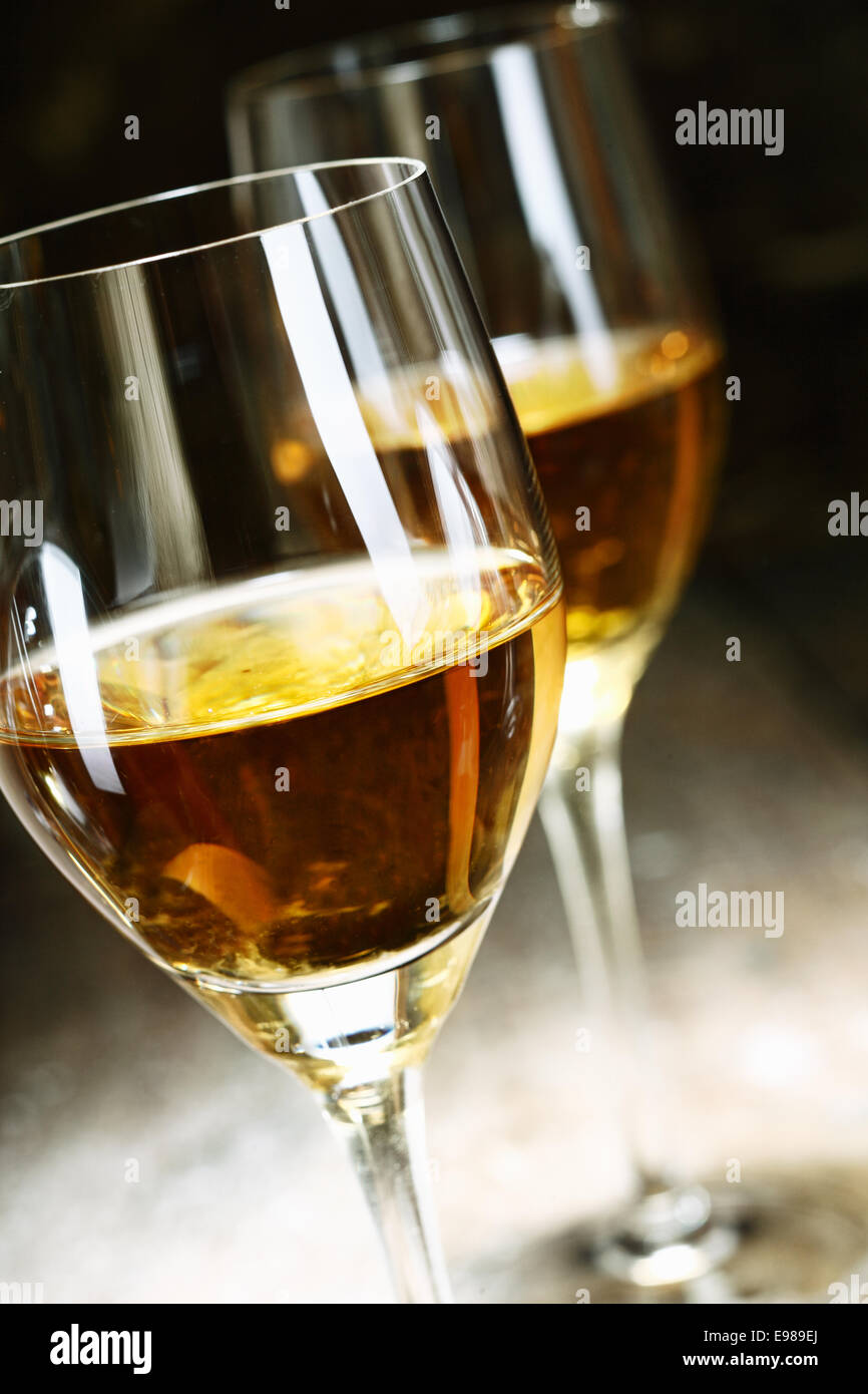 Two glasses of sherry on brown wooden background Stock Photo - Alamy