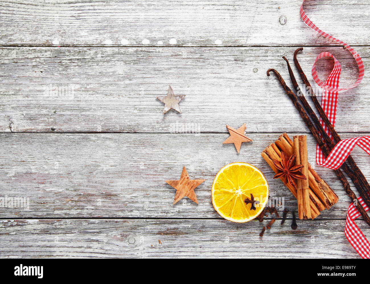 Colourful array of decorative Christmas spices with a fresh red and ...