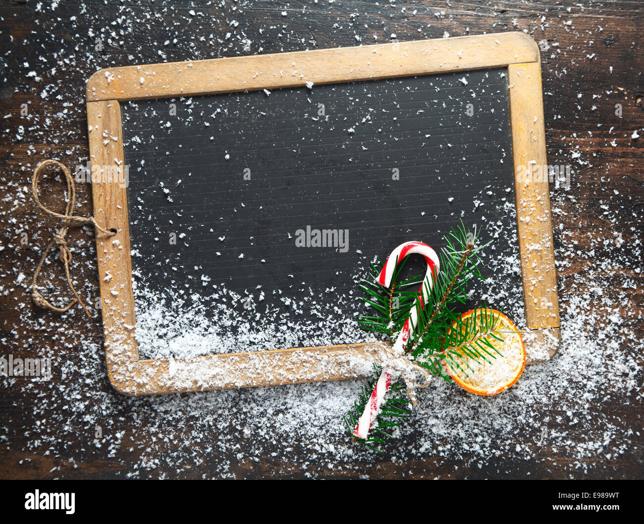 Blank rustic Christmas chalkboard slate with scattered snow and a ...