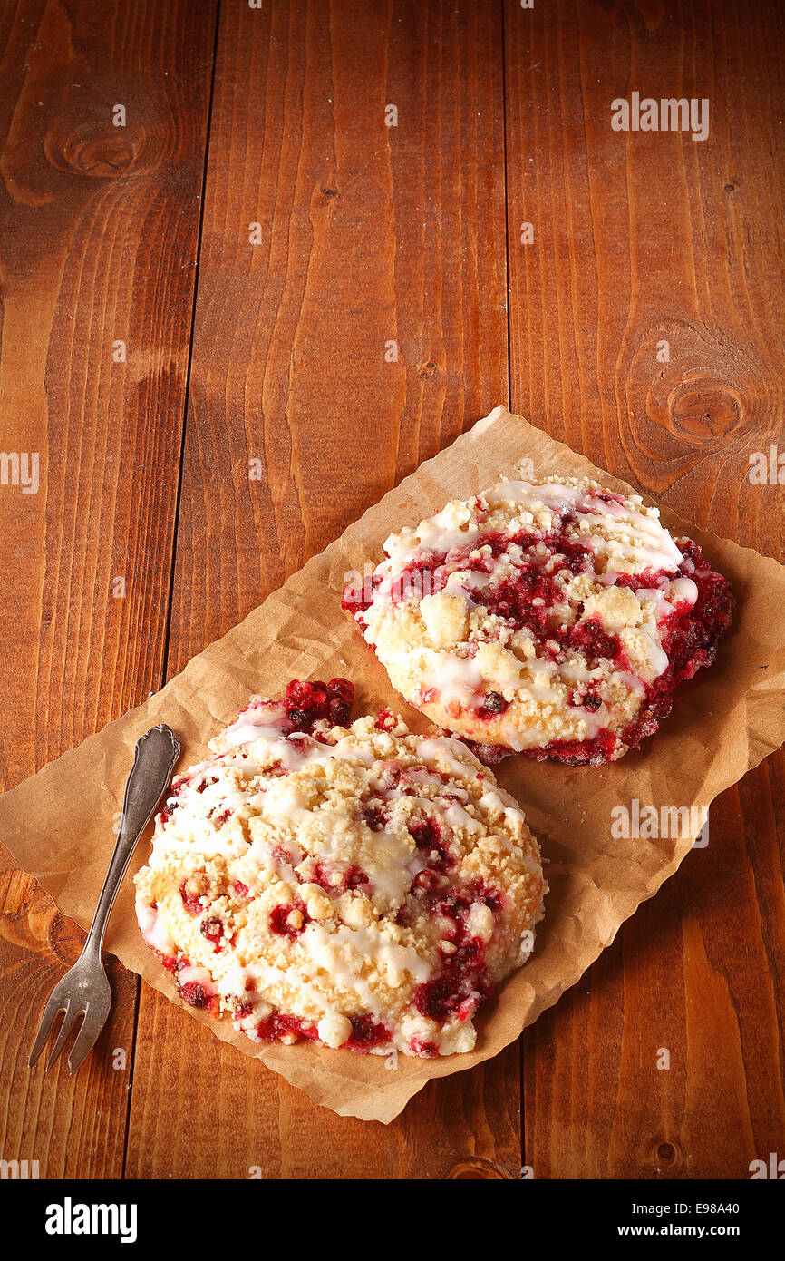 Two tasty homebaked biscuits with strawberries and cherries on a ...