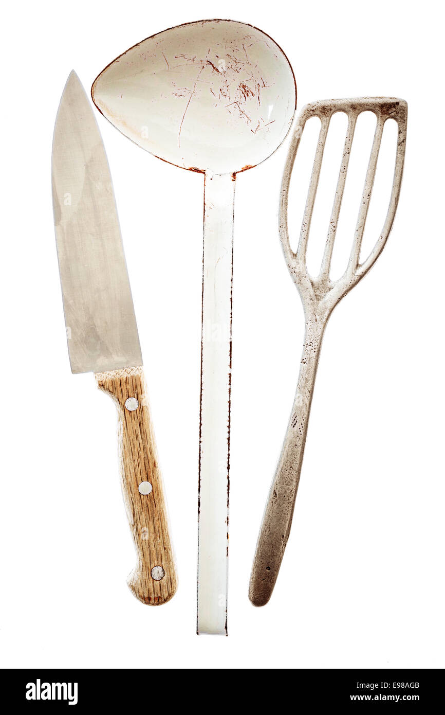 Three retro cooking utensils isolated n white with a sharp wooden ...