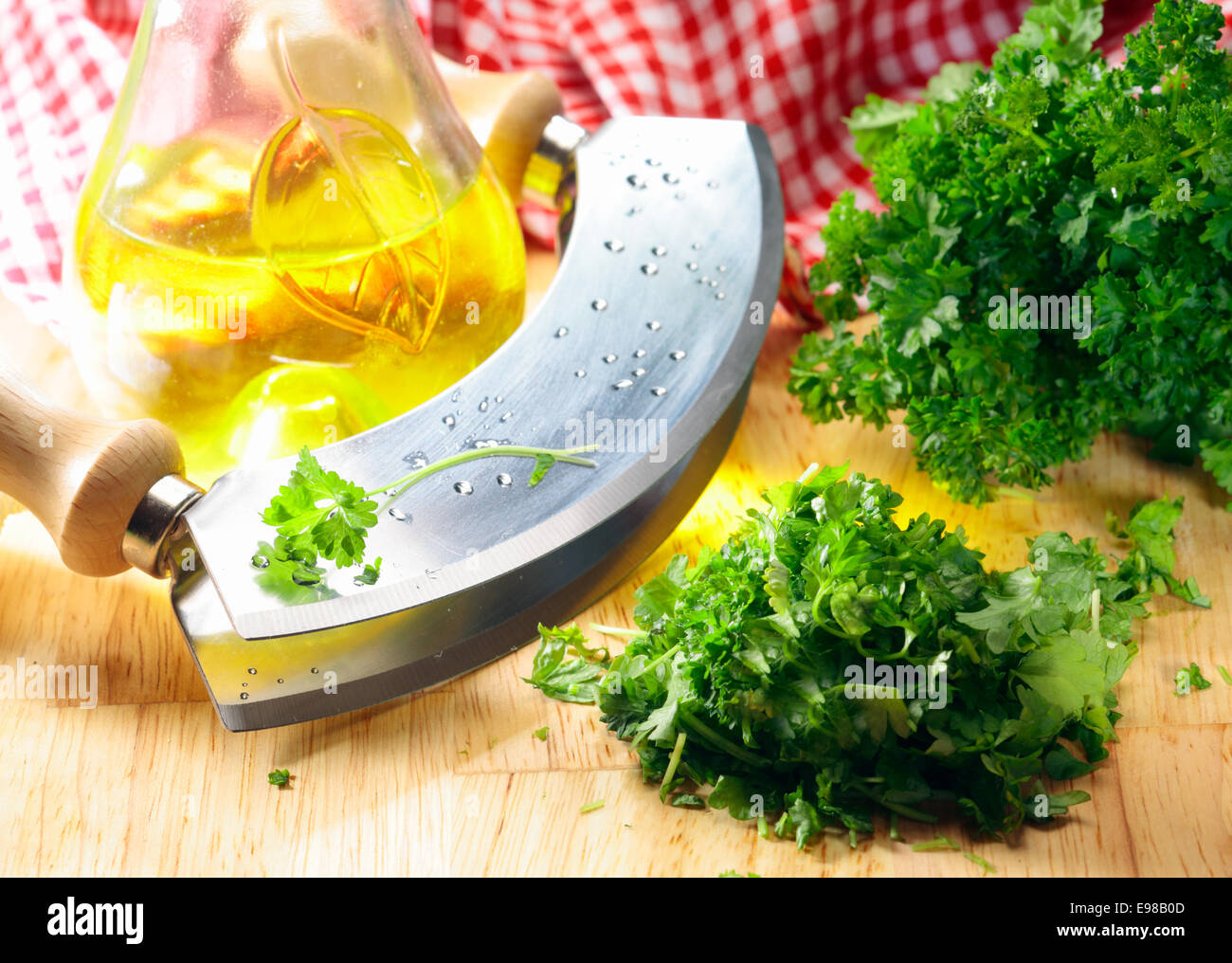 Close up of a modern herb cutter (wiegemes) with wooden handles and a ...