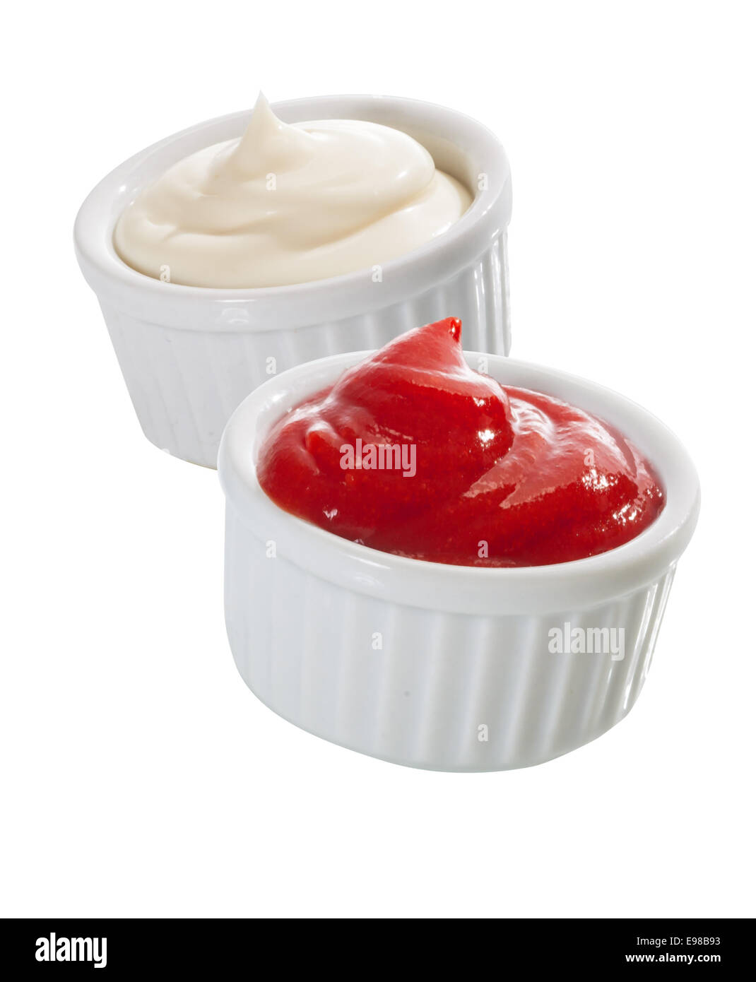 Individual small white containers or ramekins of creamy mayonnaise and ...