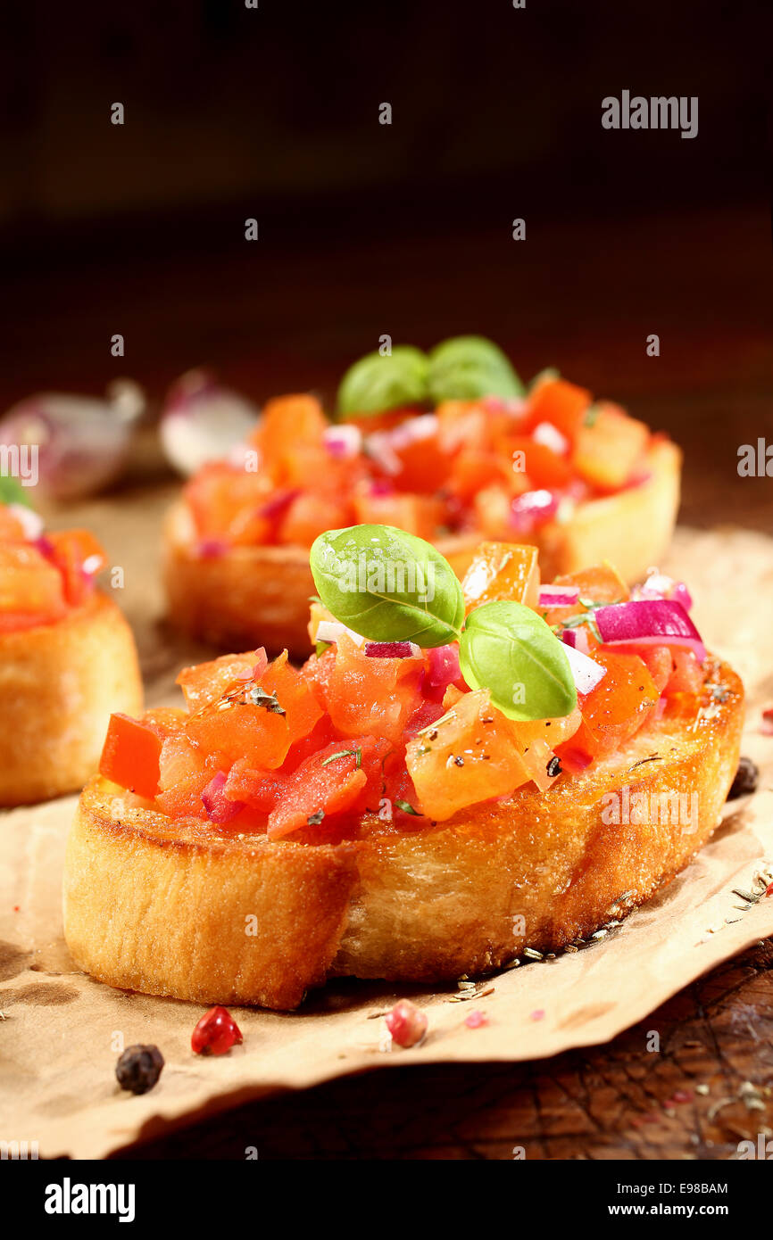 Colourful Italian vegetable bruschetta with ripe red chopped tomato on ...
