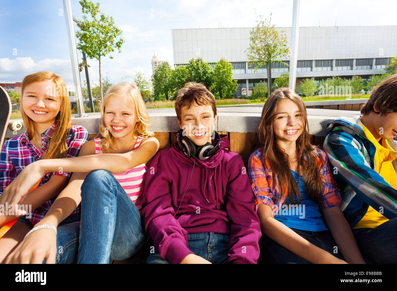 Group of children sitting close to each other Stock Photo - Alamy