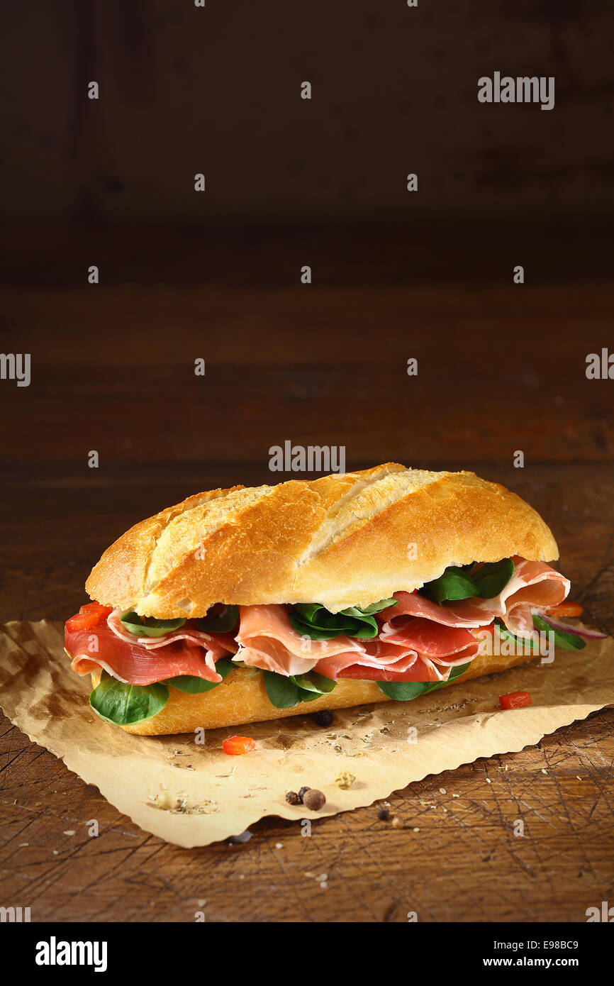 Fresh basil and thinly sliced cold ham on a crusty freshly baked ...