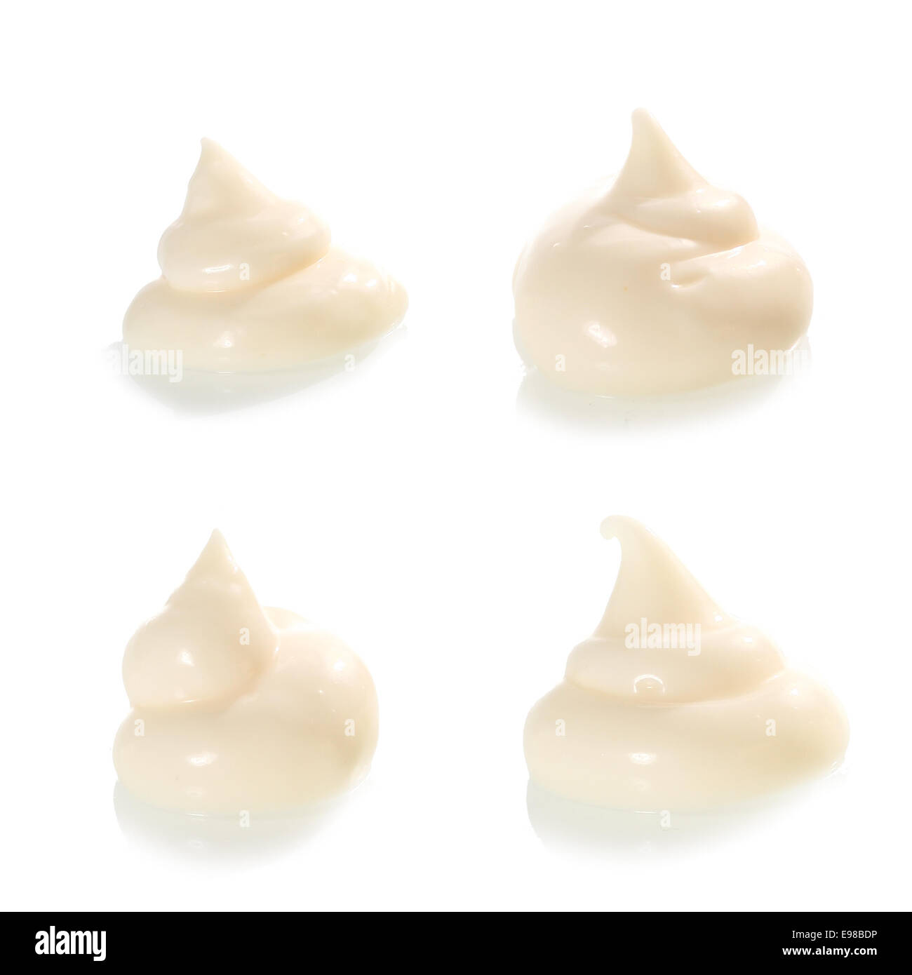 Close-up of four piles of mayonnaise or white creamy dressing, on white ...