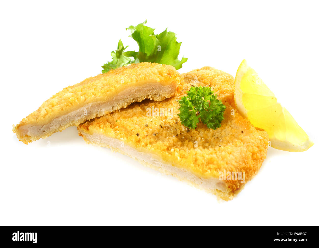 Delicious golden deep fried crumbed chicken or pork fillet cut through ...