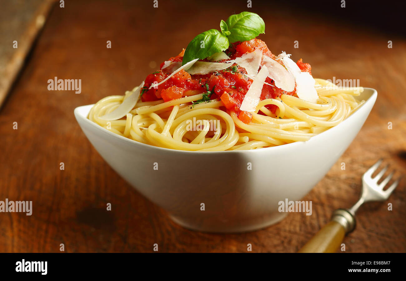 Decorative white ceramic bowl of cooked Italian spaghetti with tomato ...