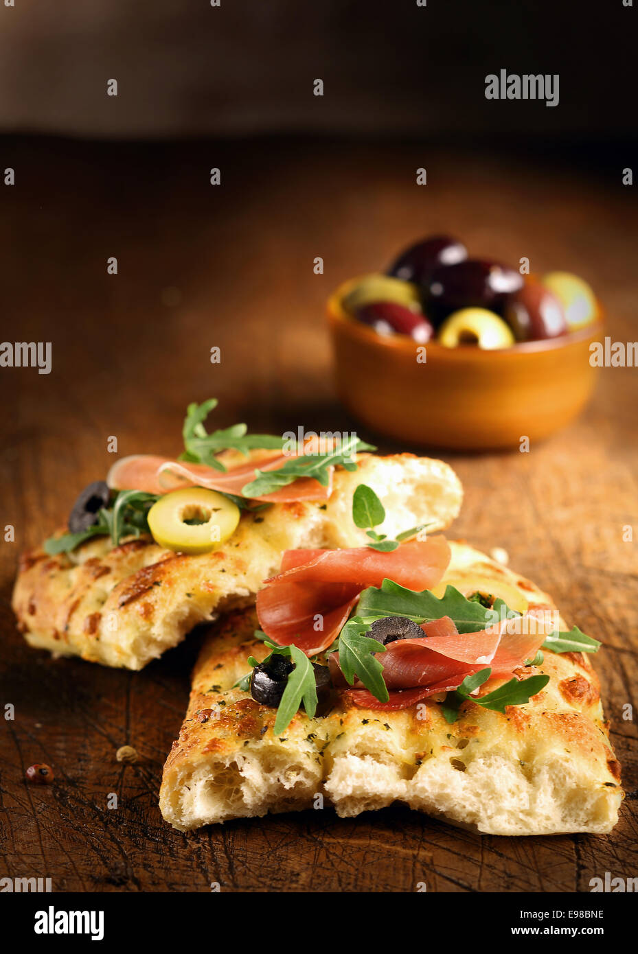 Serving of fresh traditional oven-baked Italian focaccia bread with ham ...