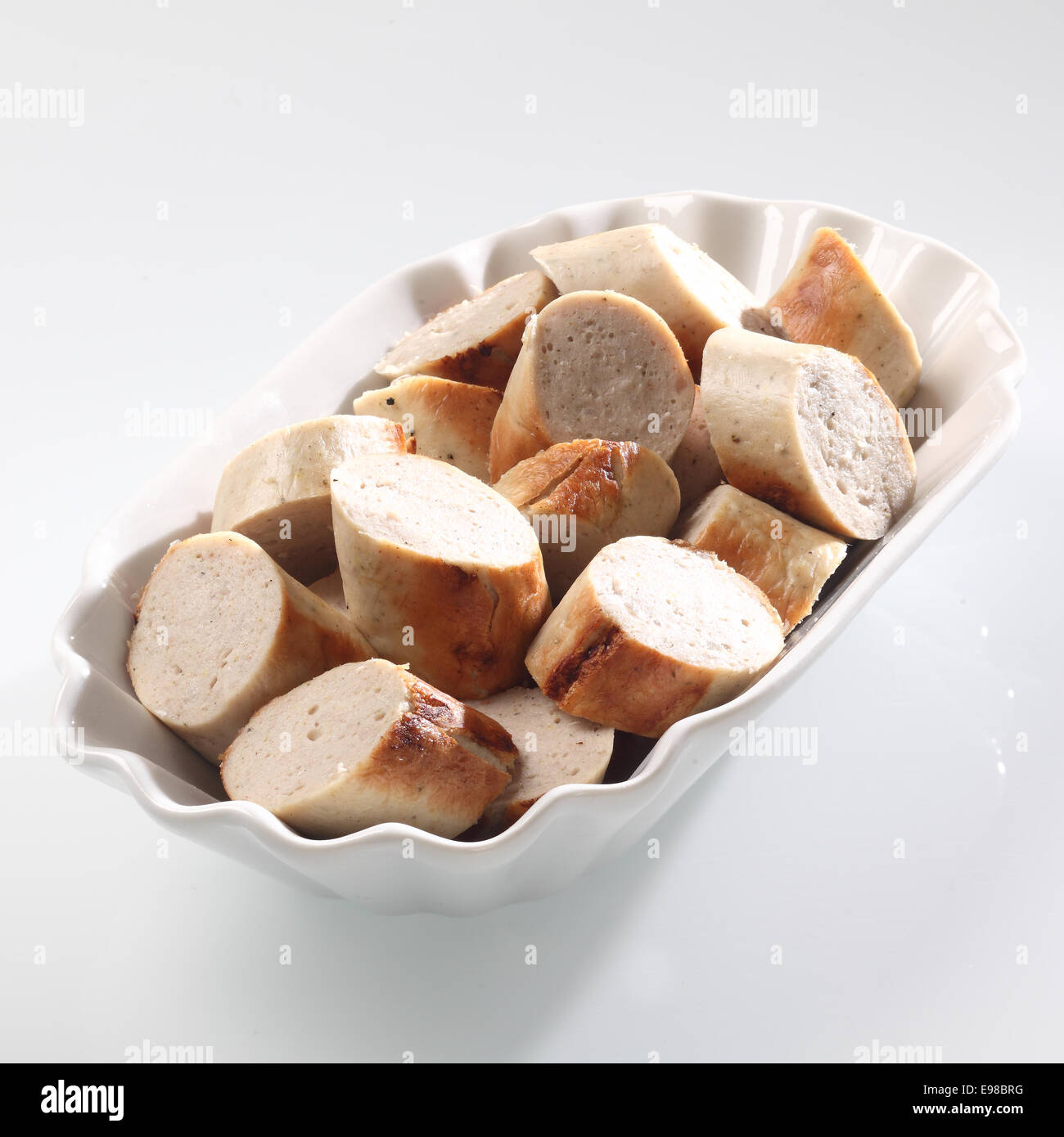 Sliced cooked spicy sausage served in a dish as an appetizer of finger ...