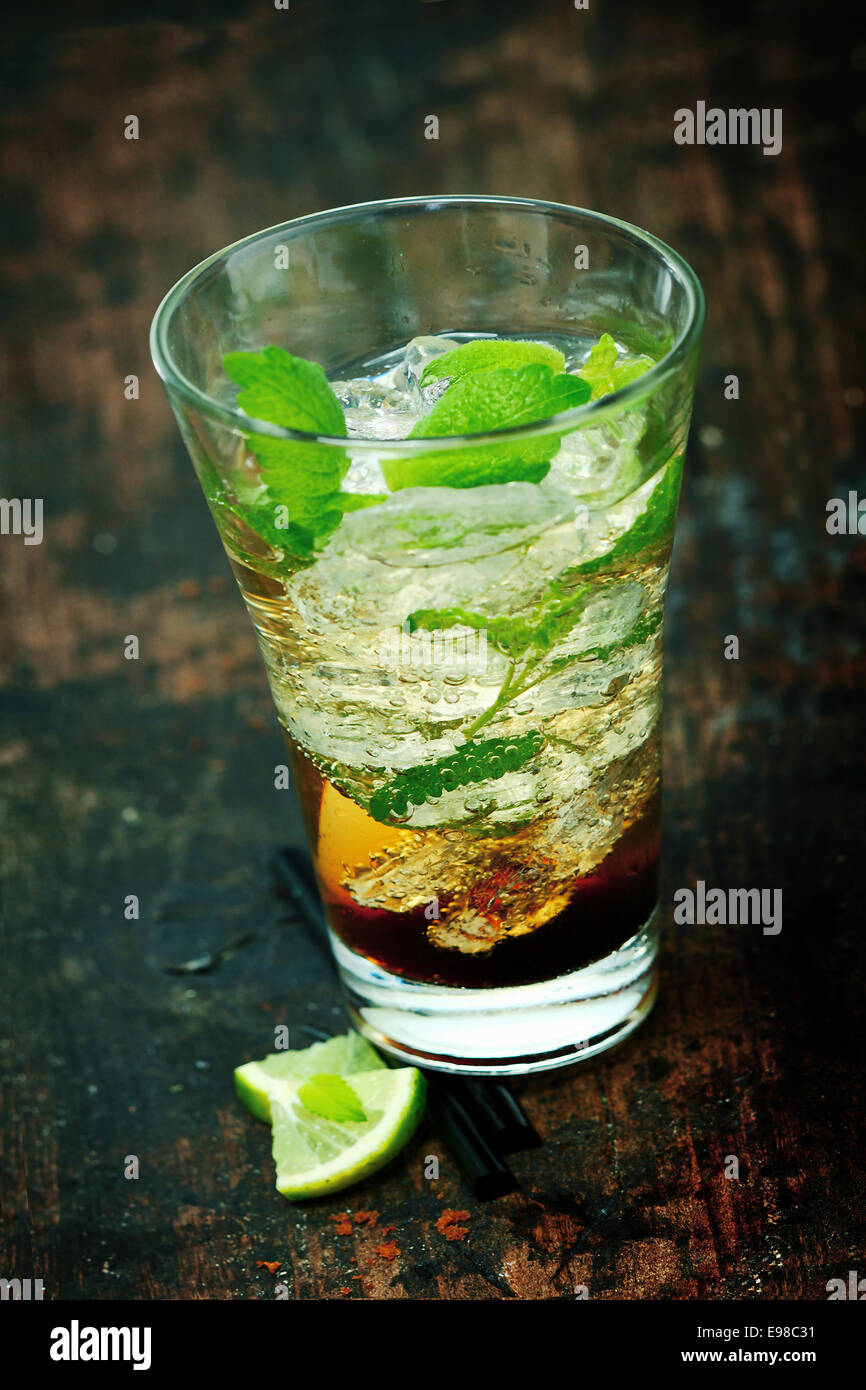 Large mojito rum cocktail with ice, rum, lime jiuce, and mint leaves ...