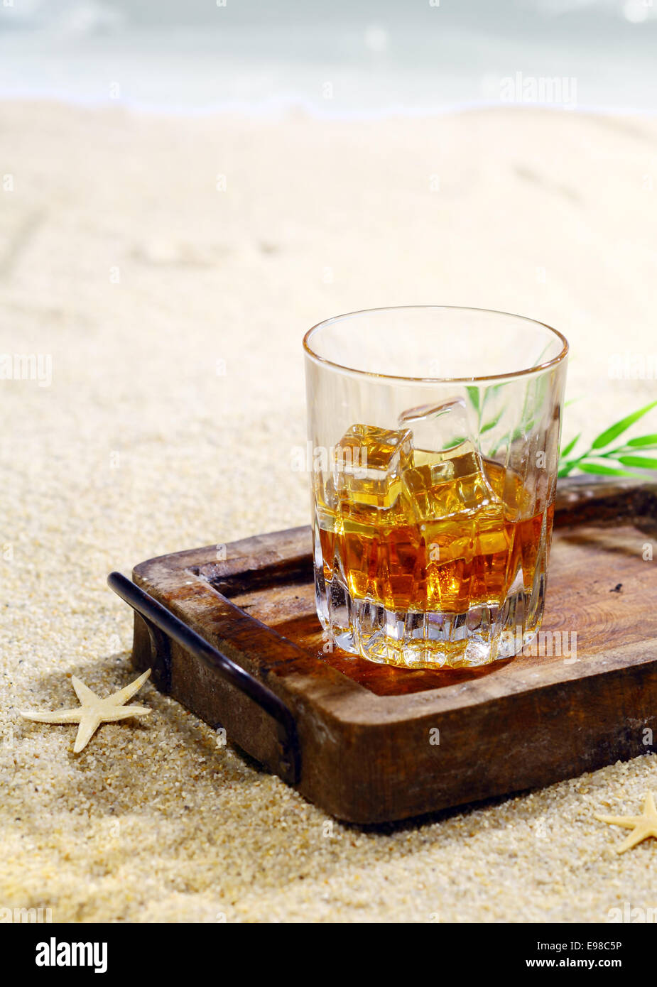 Beautiful photograph of a glass of scotch with ice cubes in a classy ...