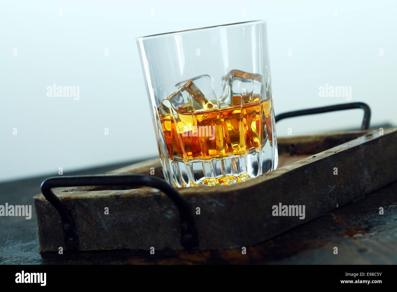 Close-up image of a glass of scotch on the rocks in a tray. Look at my ...