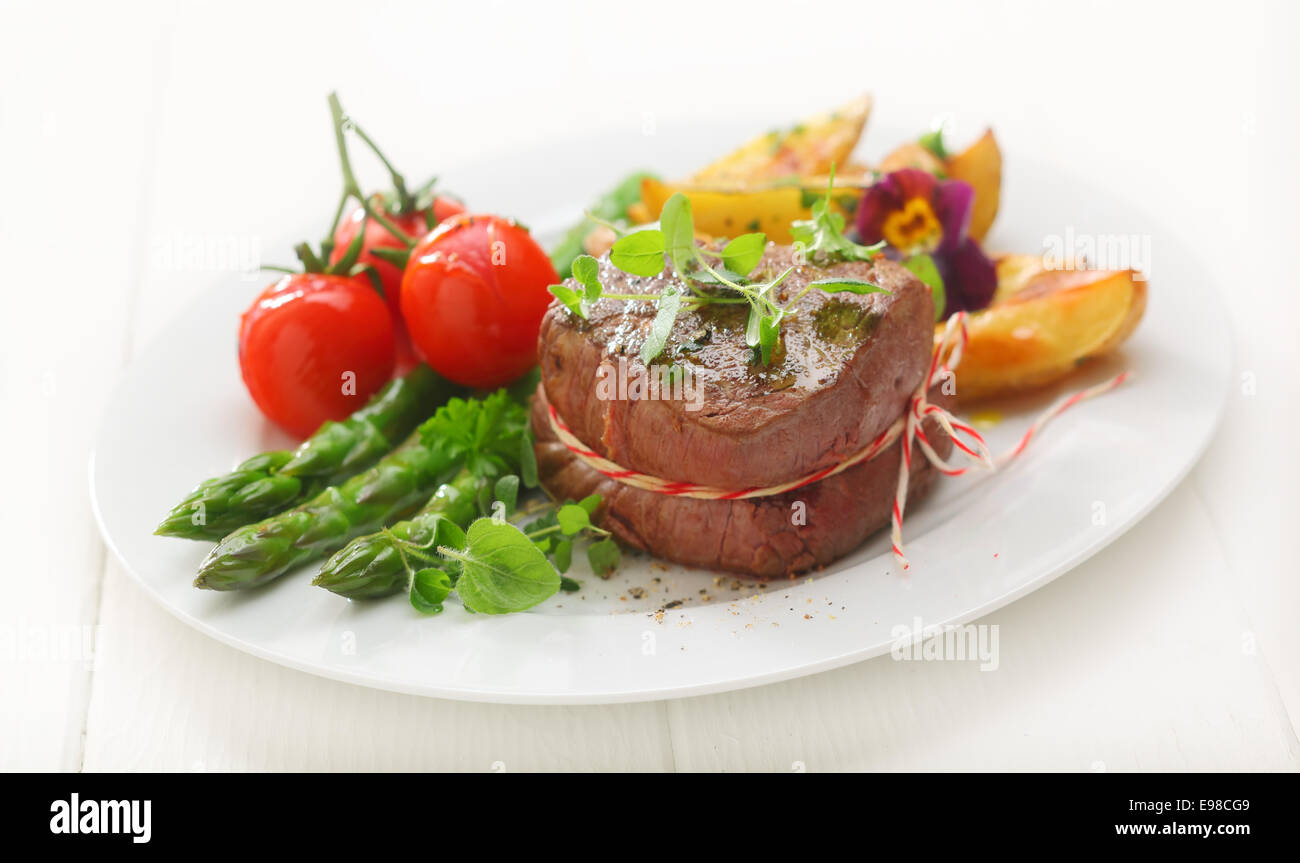 Delicious thick portion of grilled fillet steak served with fresh green ...