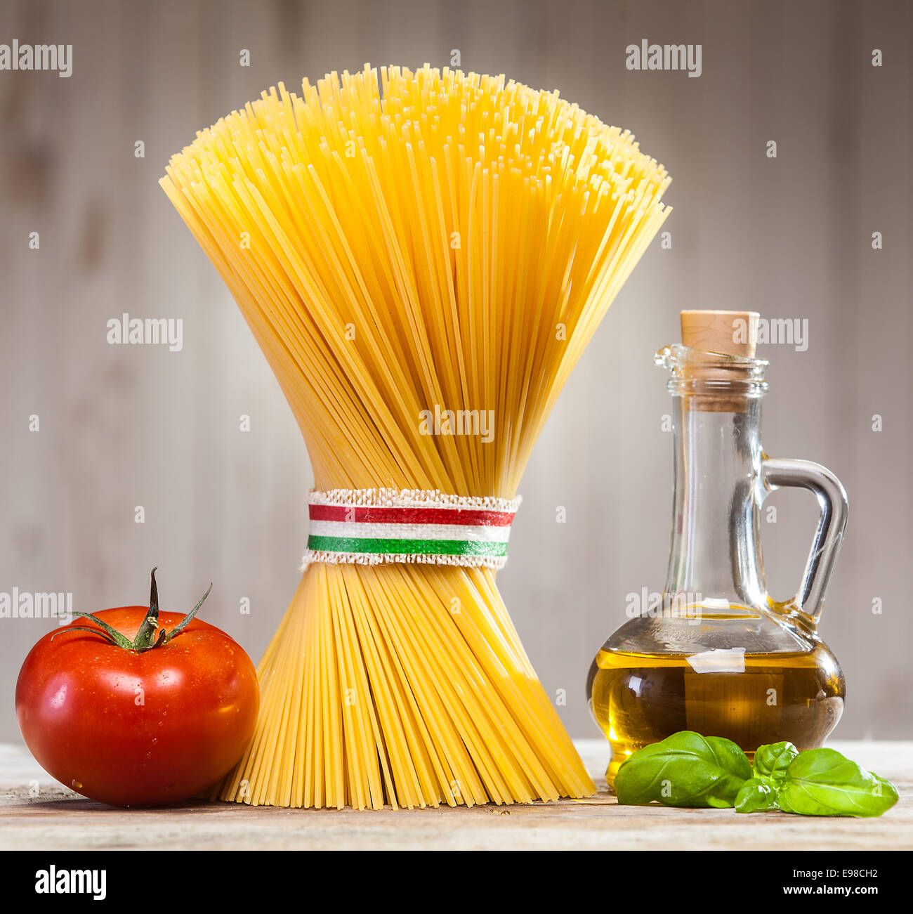 Bundle of uncooked dried Italian spaghetti tied with a ribbon in the ...