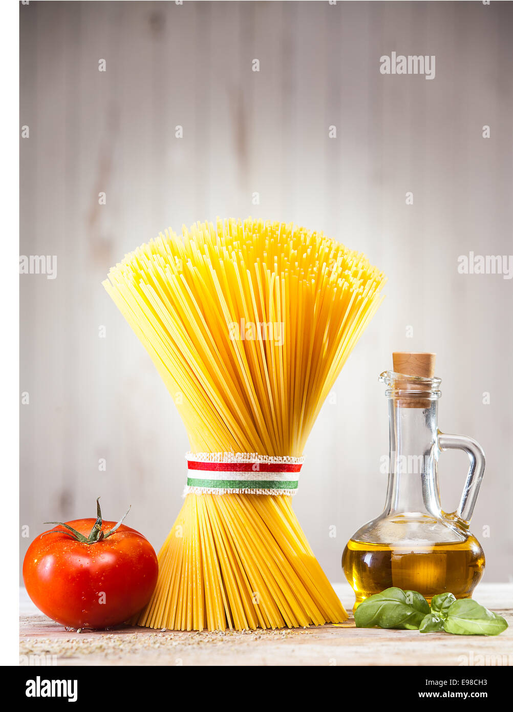 Uncooked dried Italian spaghetti tied with a ribbon in the colours of ...