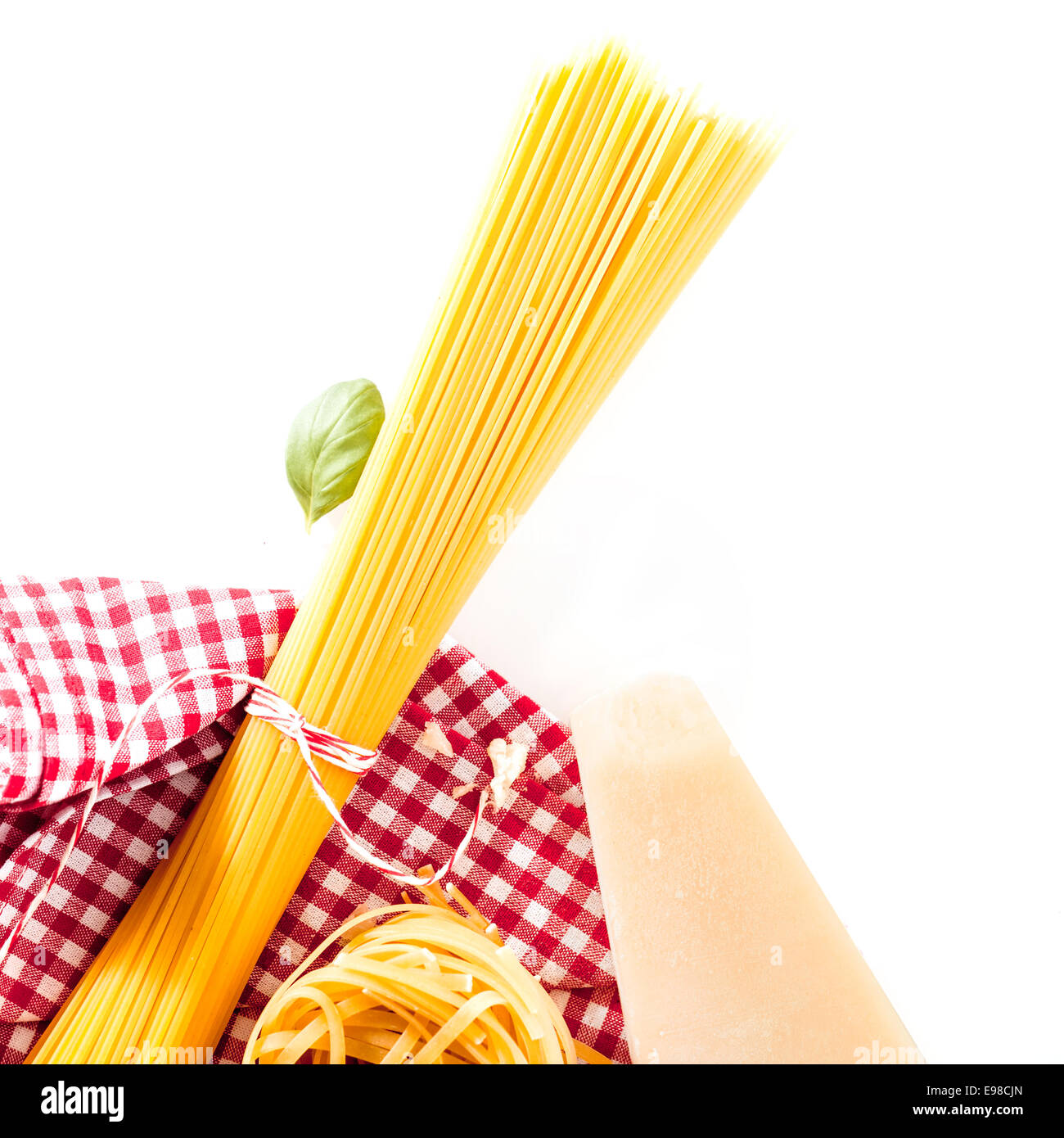 Uncooked Italian pasta, including spaghetti and fettucini, with a wedge ...