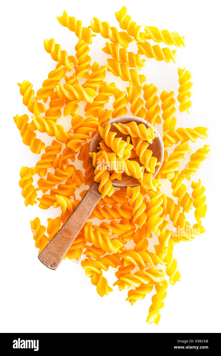 Italian raw spiral pasta and a wooden spoon, close-up shot from high ...
