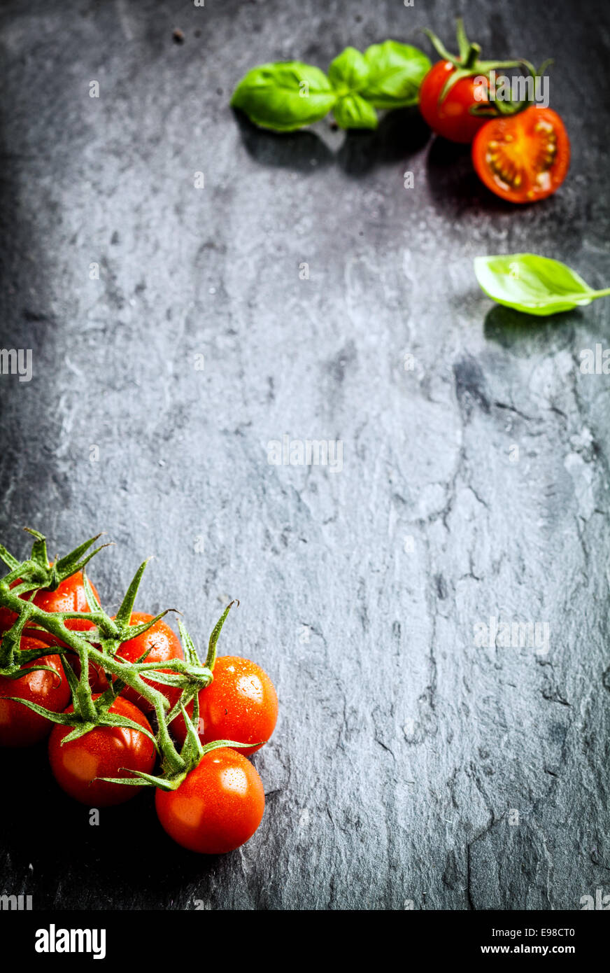 Tomatoes from above. Fresh delicious red tomatoes with basil on black ...