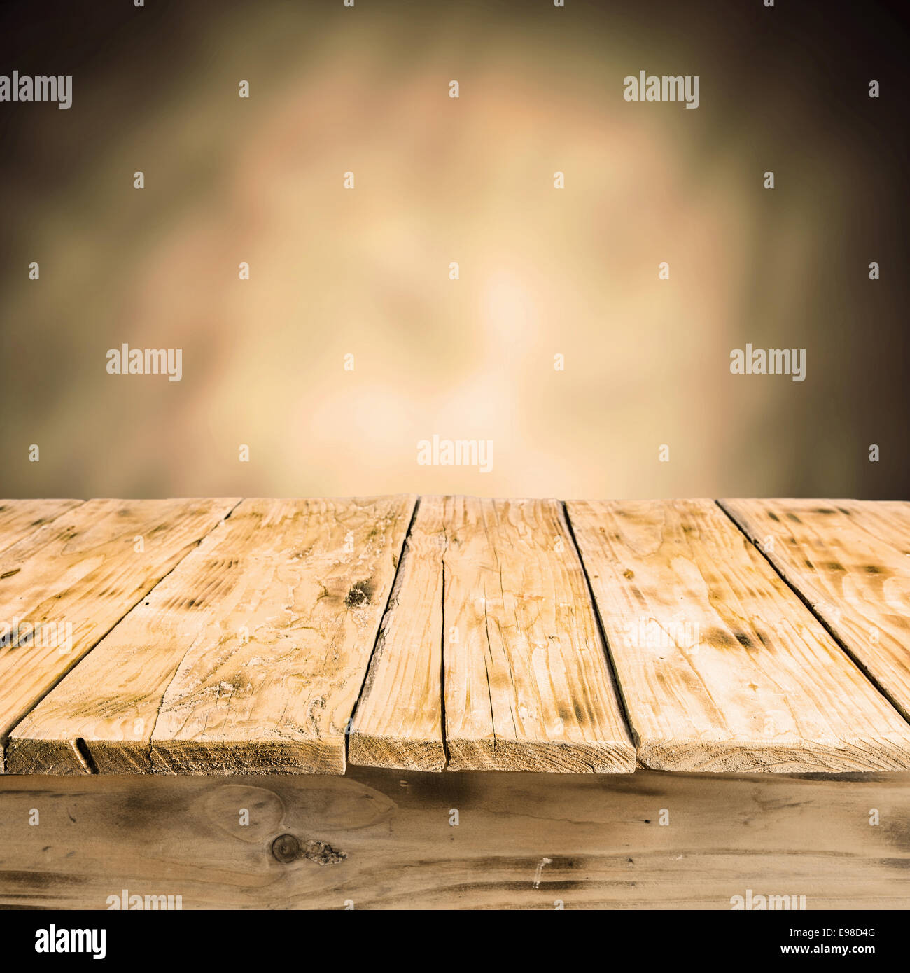 Close-up of an empty rustic wooden table made of planks, with a bright ...