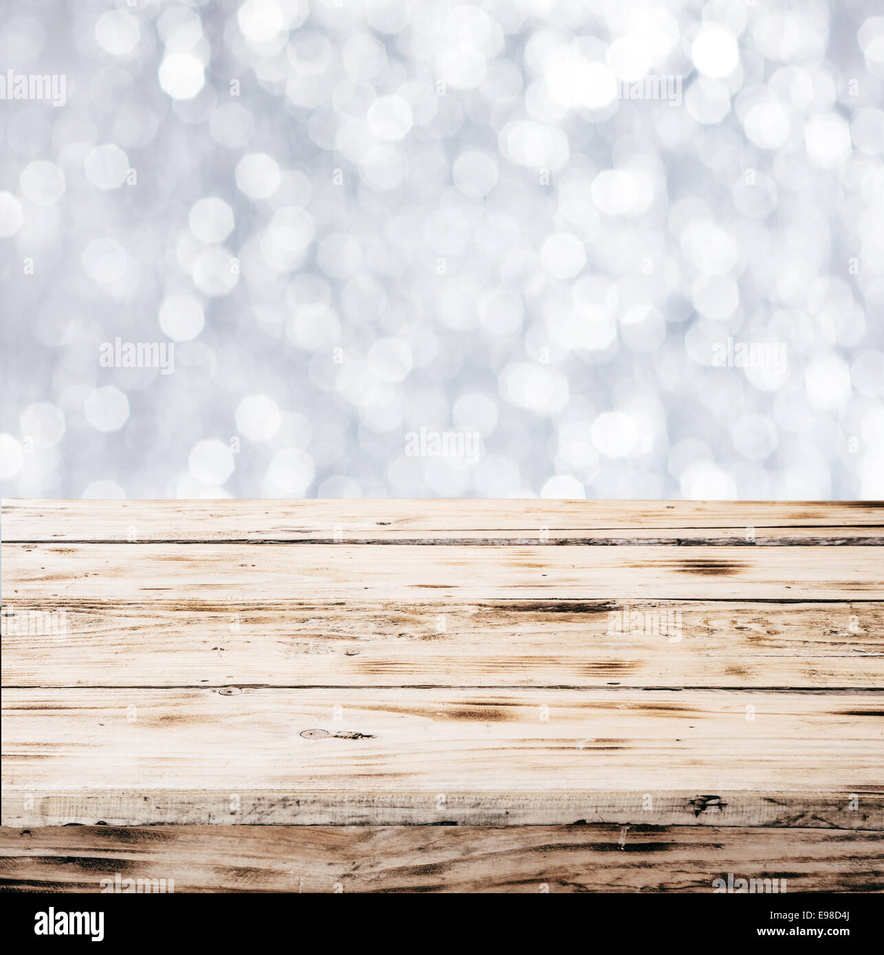 Close-up of a rustic table made of wooden planks with shiny blurred ...