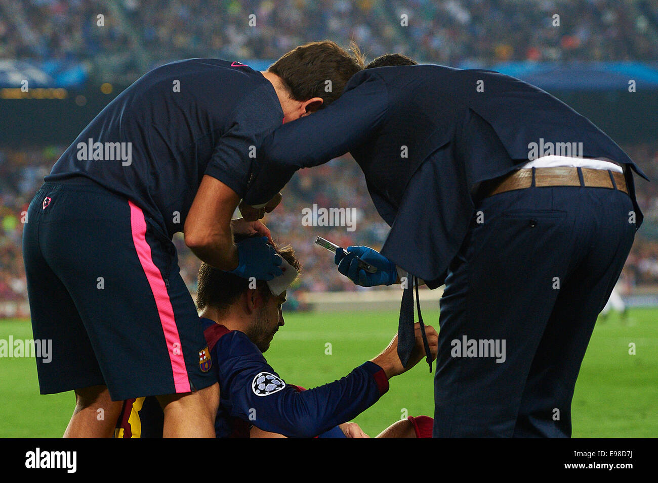 Gerard Pique (FC Barcelona) is treated by Dr Pruna, during the ...