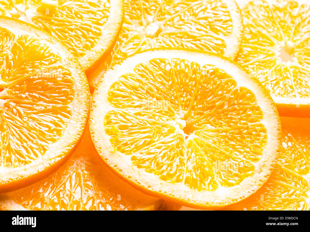Full frame background of juicy orange slices showing the texture of the ...