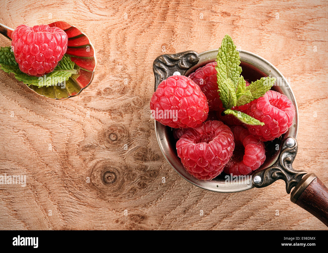 Top view of an old copper ladle and seashell shaped spoon filled with ...