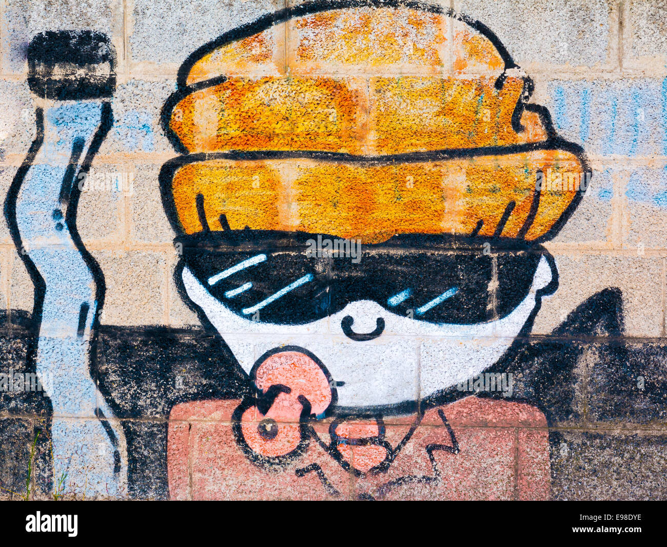 boy with sunglasses graffiti,pacifier and orange hat near a big bent ...
