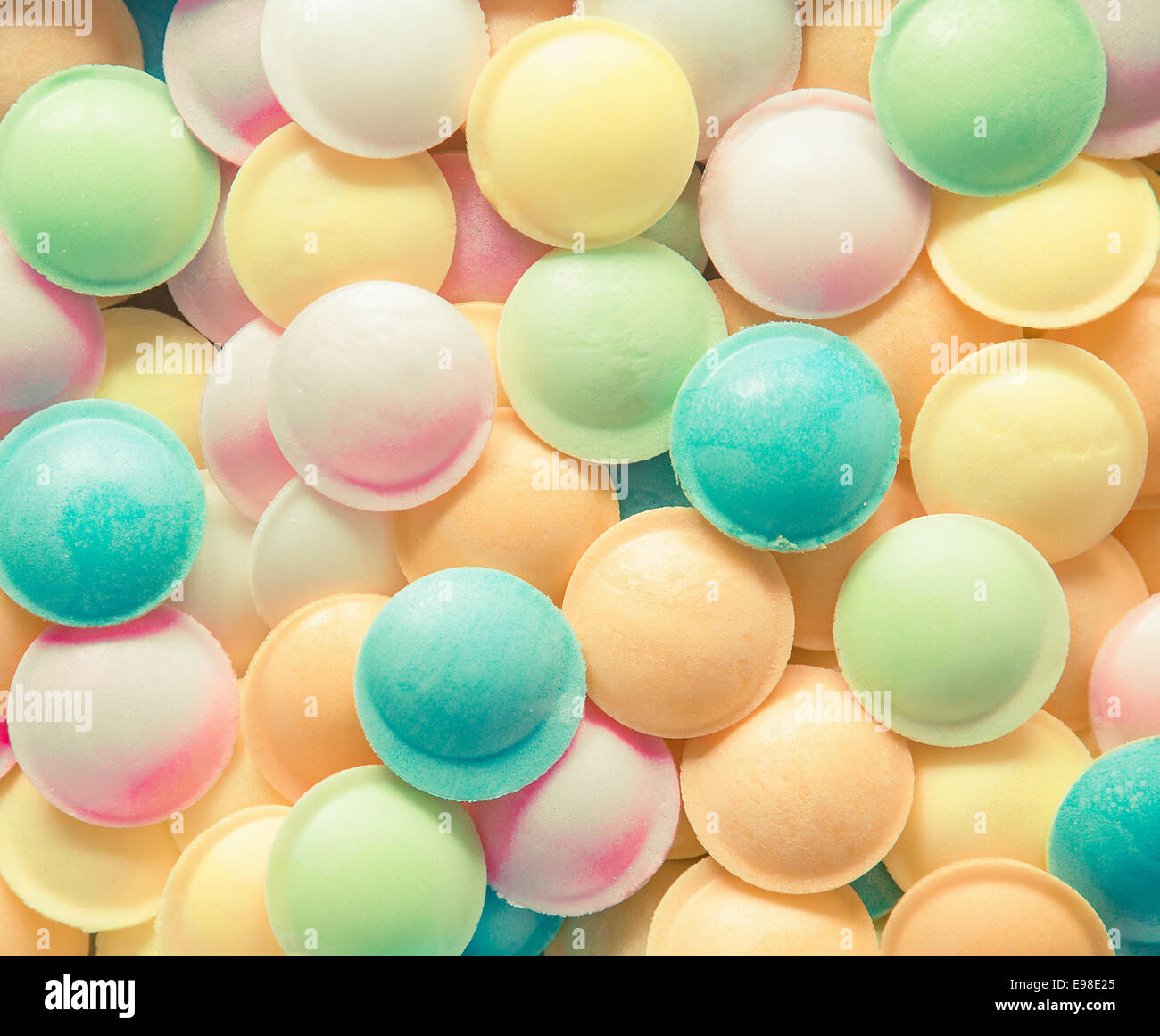Background texture made of many round candies in colorful pink, orange ...