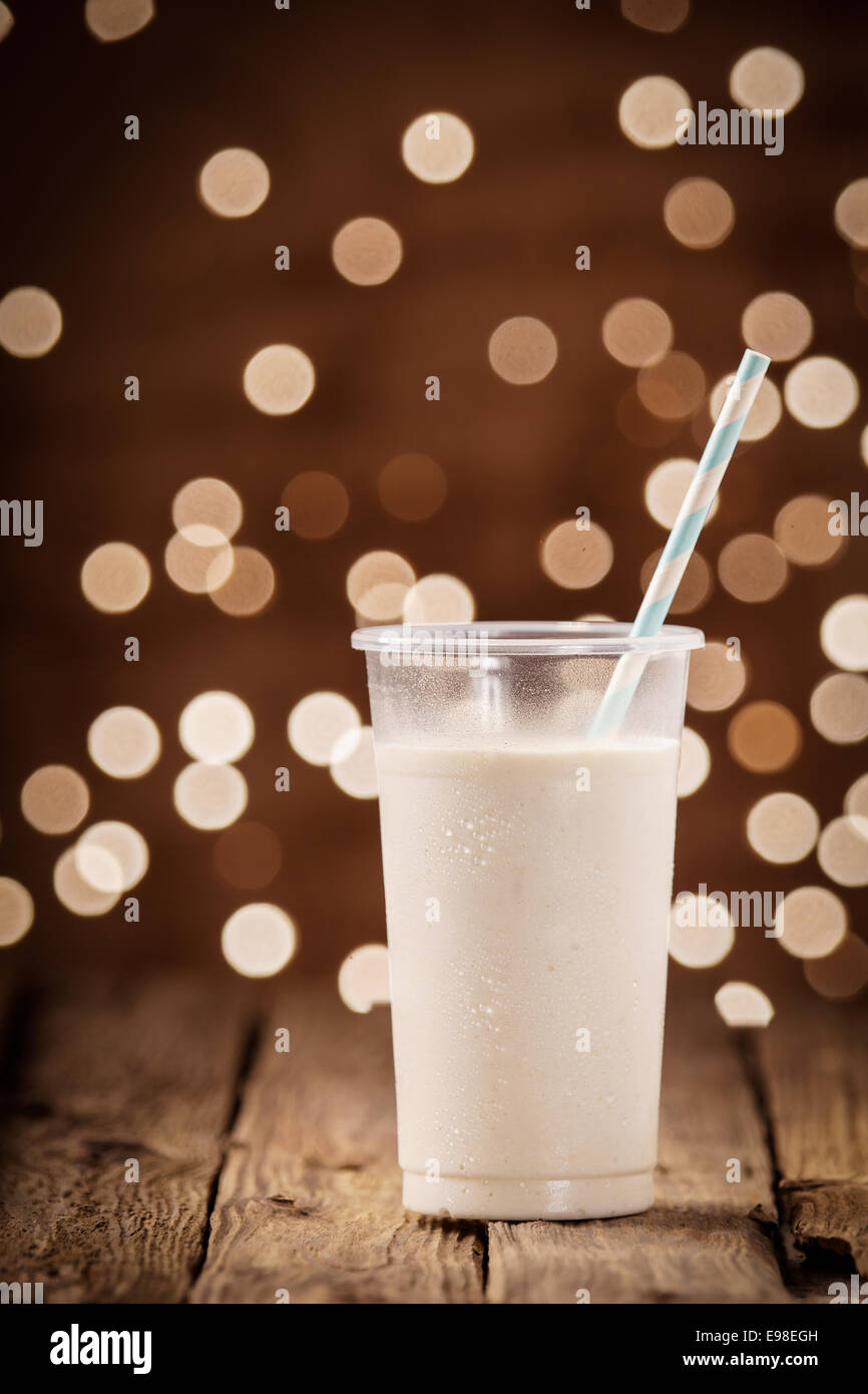 Rich creamy smoothie or milkshake blend on a party background of ...