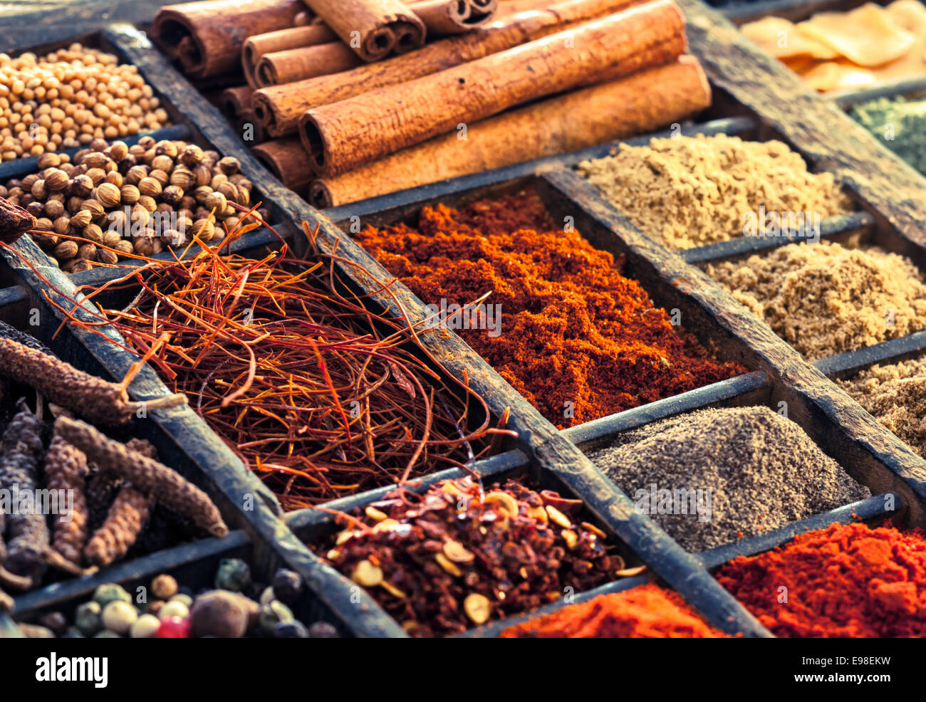 Selection of dried spices including peppercorns, red pepper, saffron ...