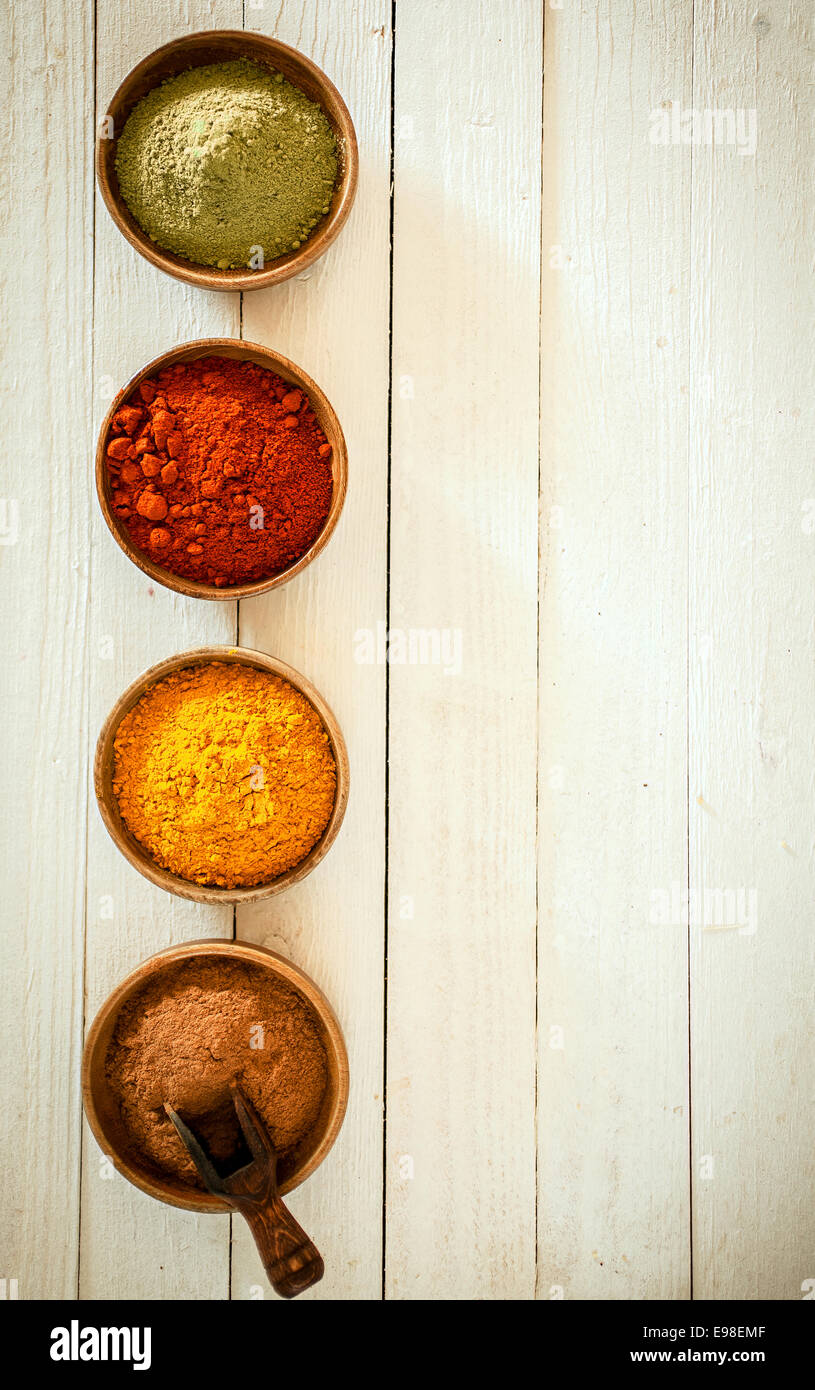 Border of colourful spices arranged in a vertical row with chilli ...