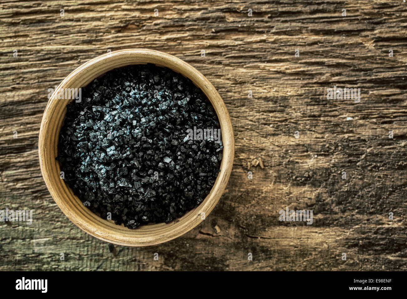 A wooden bowl filled with Hawaiian Lava Salt crystals, a sea salt ...