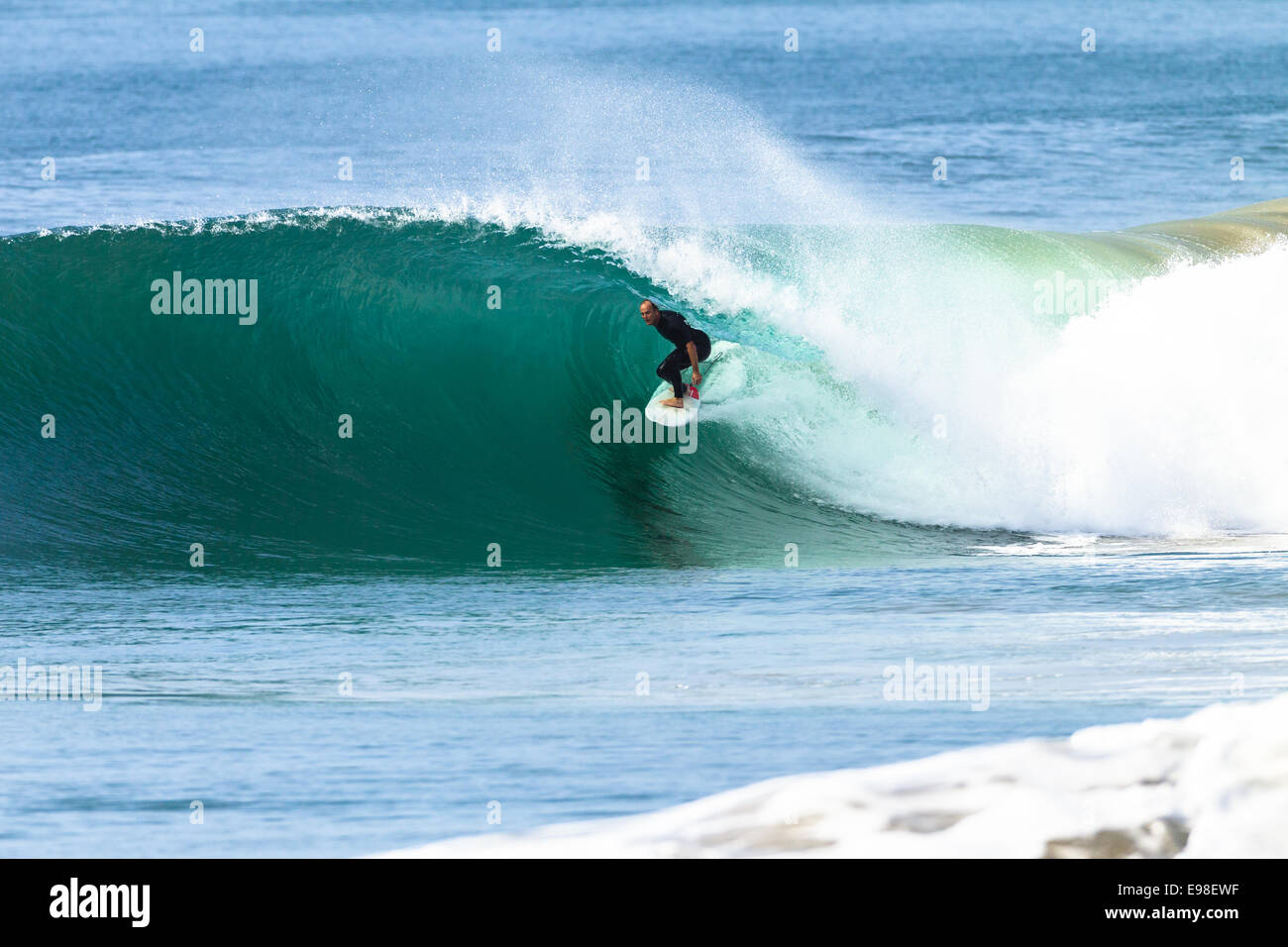 Surfer surfing rides ocean wave close photo action Stock Photo - Alamy