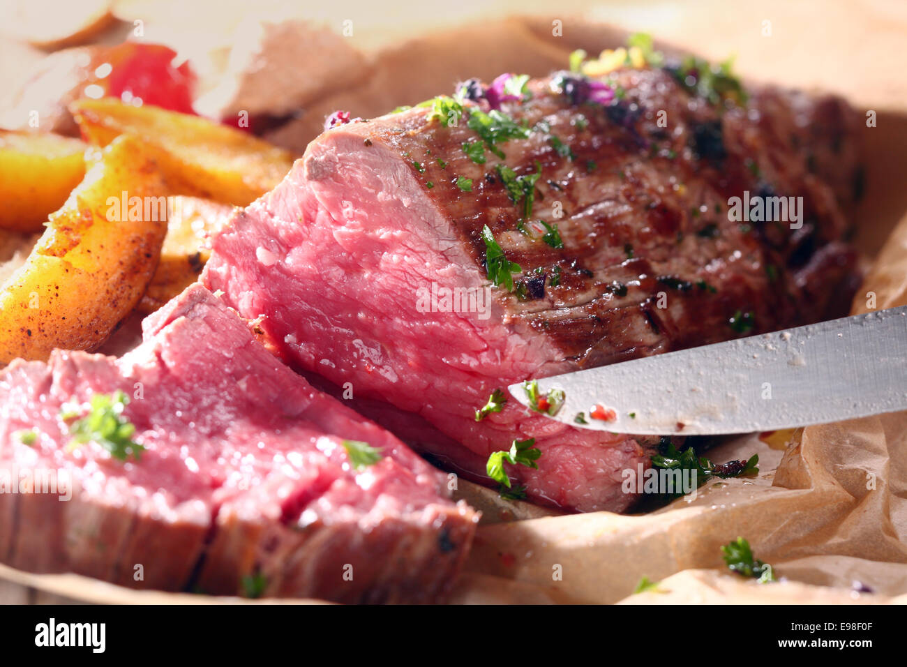 Delicious dinner of savory rare roast beef cooked with fresh herbs and ...