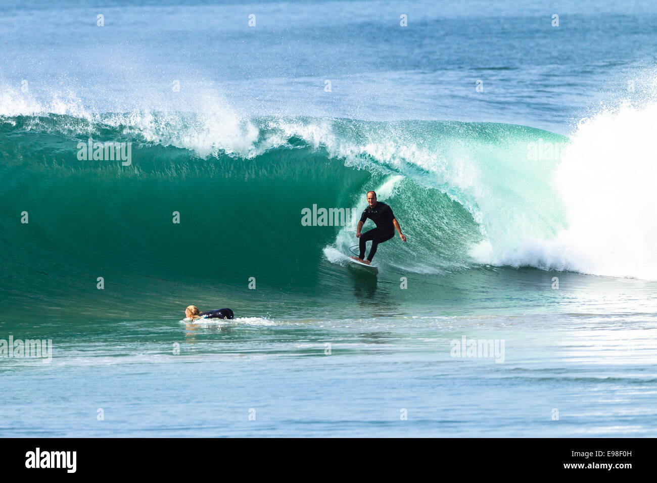 Surfer surfing rides ocean wave close photo action Stock Photo - Alamy