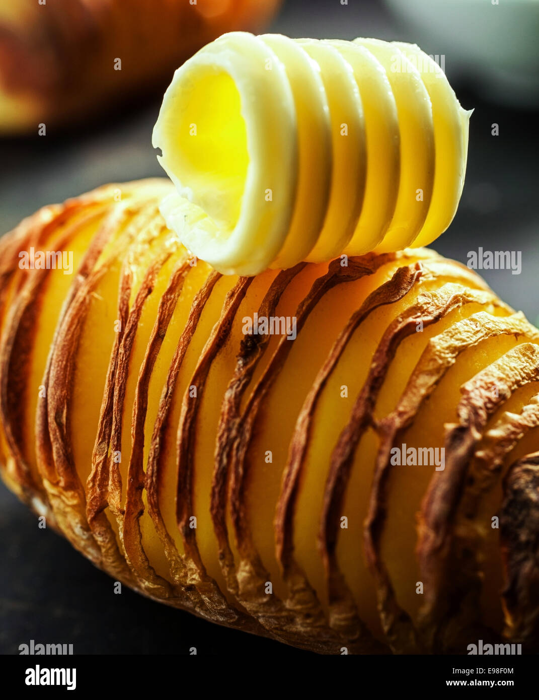 Healthy sliced baked potato cooked with the jacket on in foil and ...