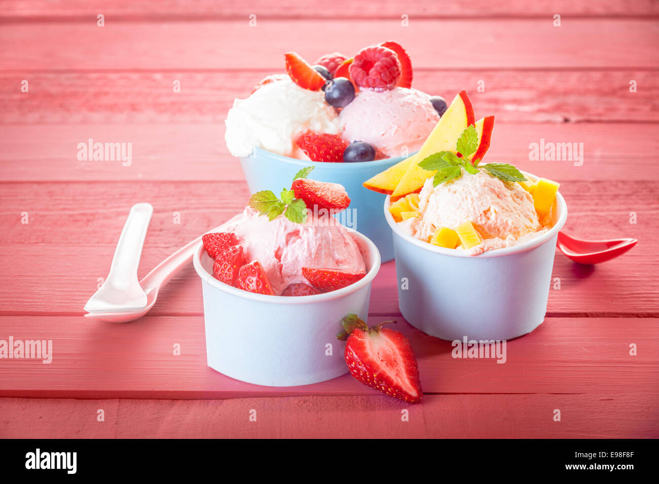 Trio of individual servings of mixed fresh berries and tropical fruit ...